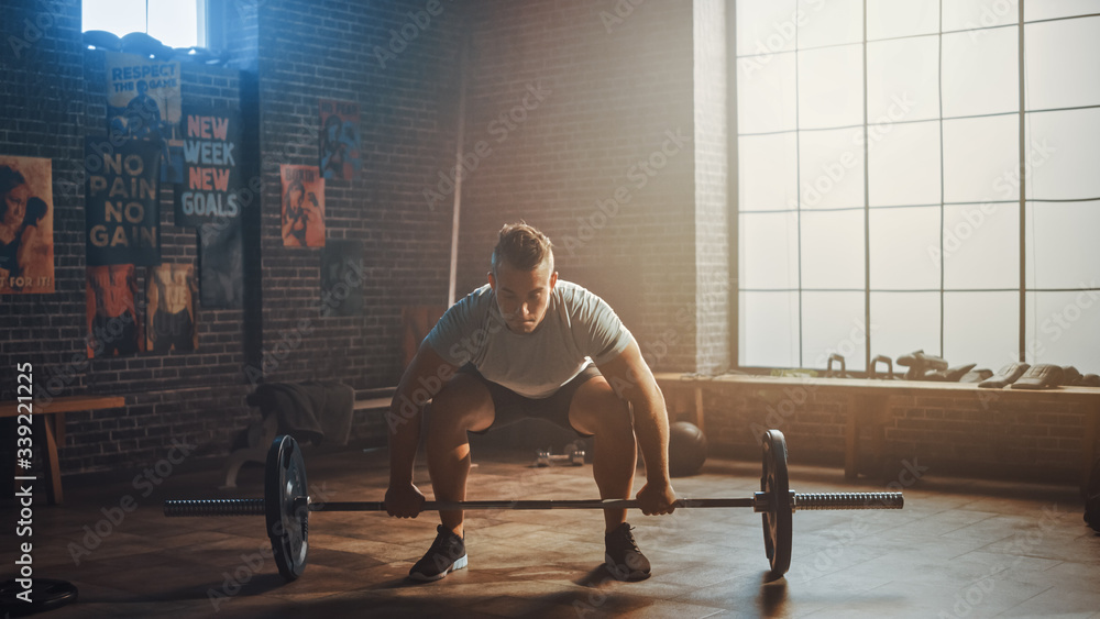 Handsome Muscular Man Does Workout with a Barbell in a Small Authentic ...
