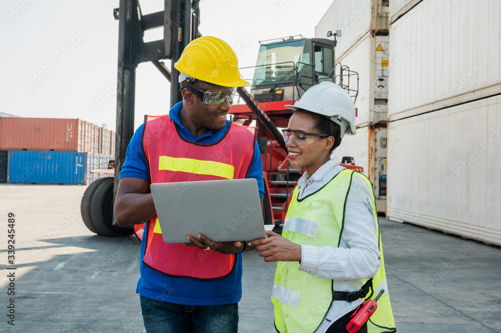 Two Black foreman man & woman worker working checking at Container ...
