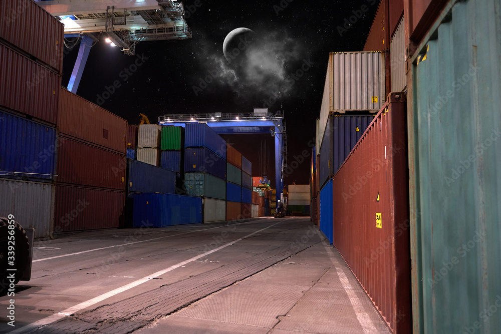 operation of container terminal at night. Unloading container ship at ...