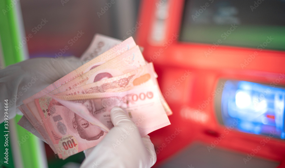 Female hands to holding cash from ATM key in the red cabinet. Finger ...