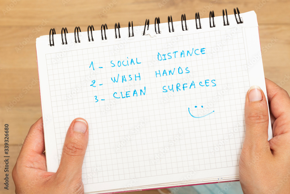 Coronavirus COVID-19 health safety guidelines. hands holding notebook ...