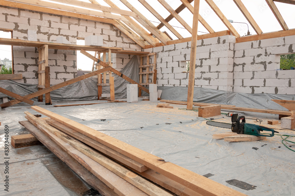 Installation of wooden beams. Rafter system on the mansard roof on a ...