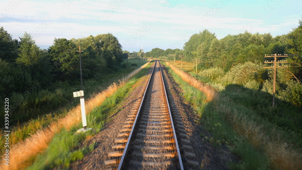Back view of railroad and a beautiful green nature from a train passing ...