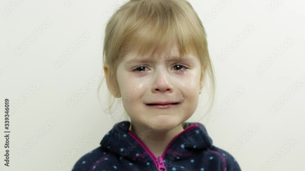 Portrait of little child girl crying with tears down her face. White ...