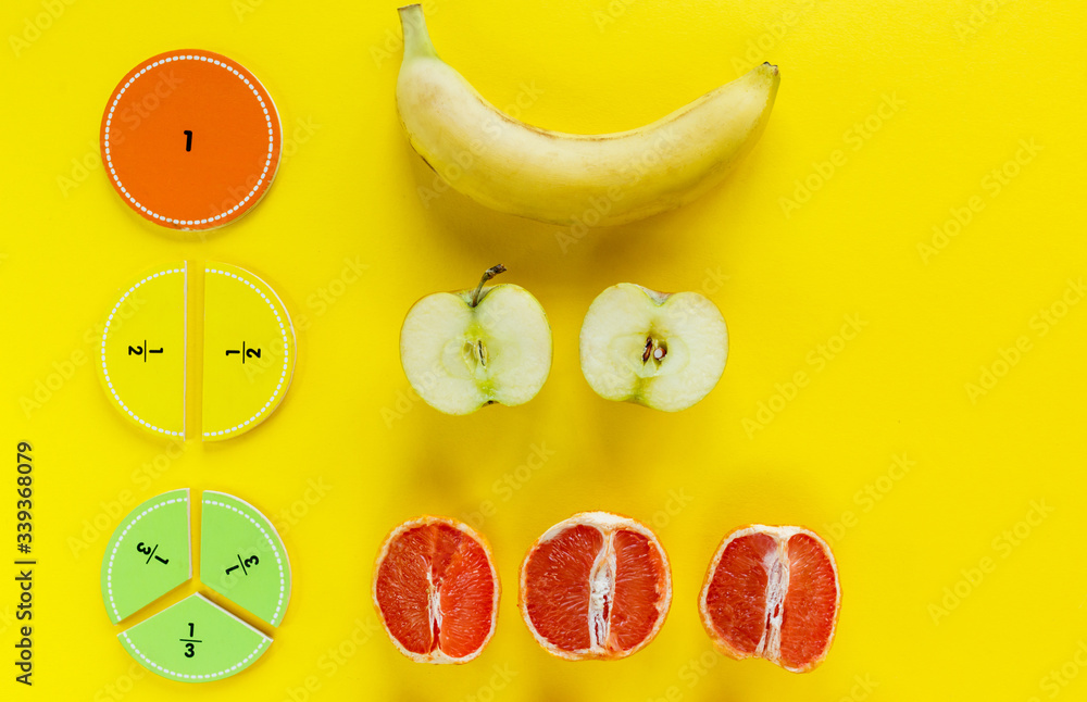 Foto de Colorful math fractions and apples, oranges, banana as a sample ...