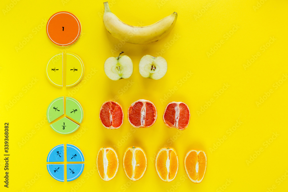 Colorful math fractions and apples, oranges, banana as a sample on ...