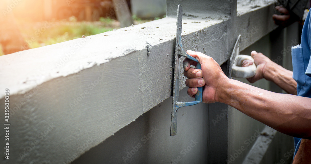 Construction workers in industrial buildings are plastering to build ...