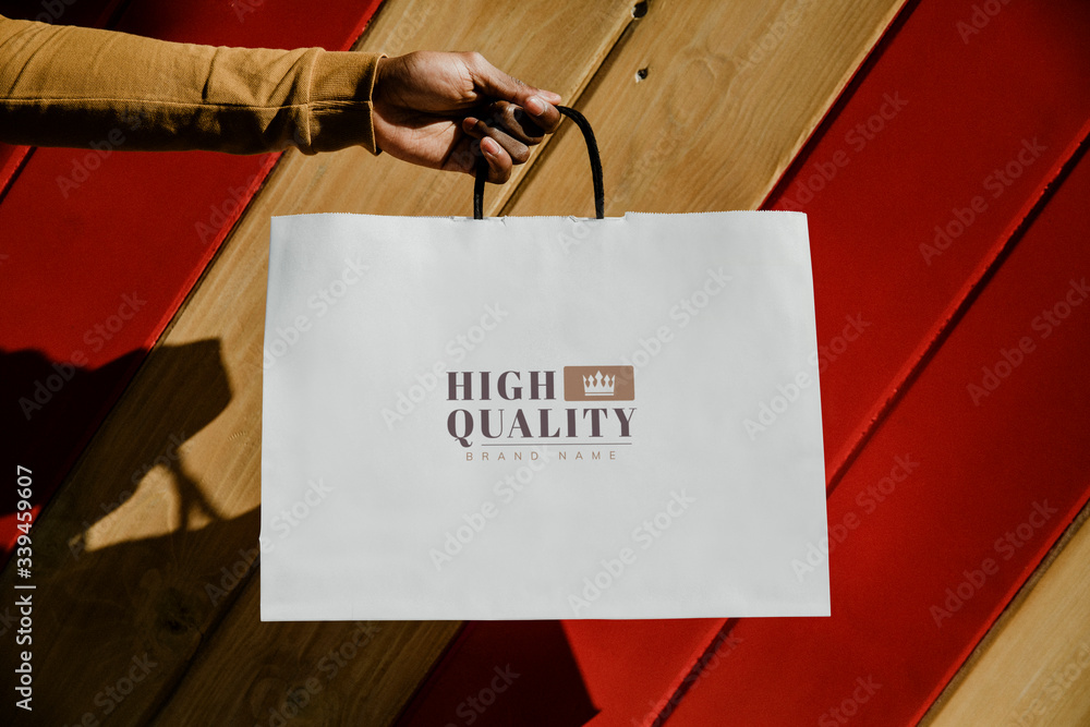 Hand carrying a paper bag Stock Photo | Adobe Stock