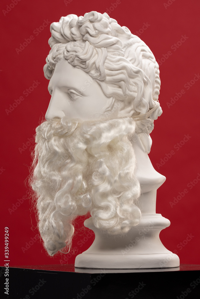 White plaster statue of a bust of Apollo Belvedere with a long white ...