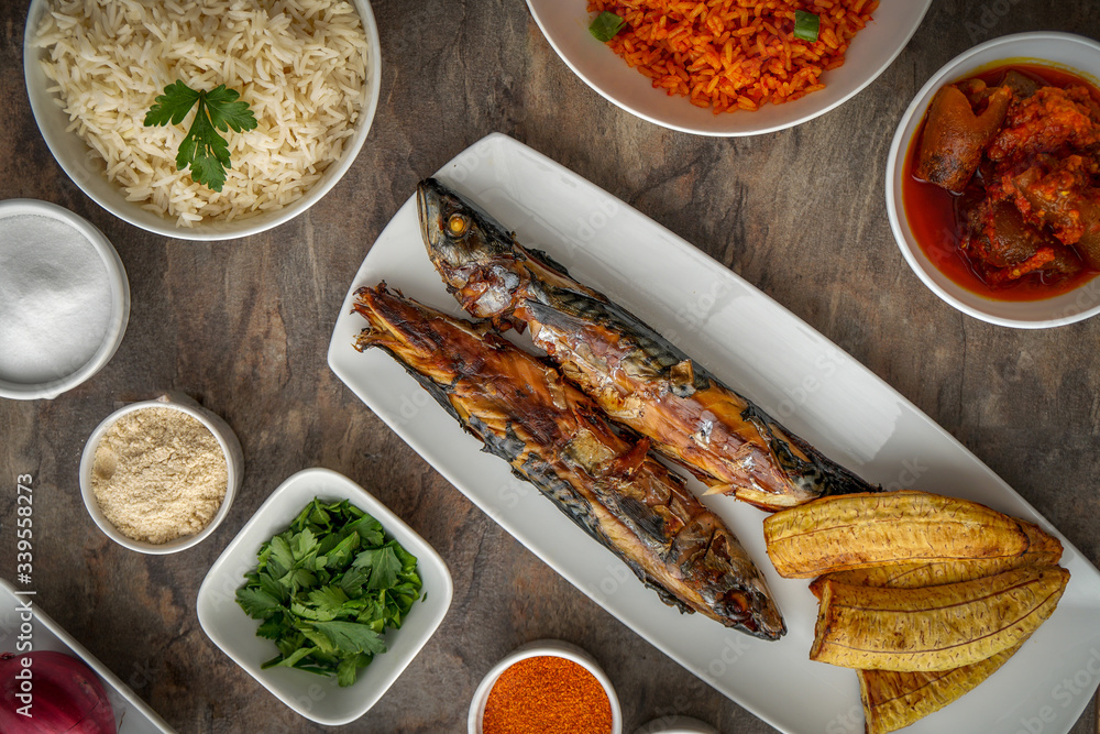 African national fried food dish. Grilled fish with plantain. Nigerian ...