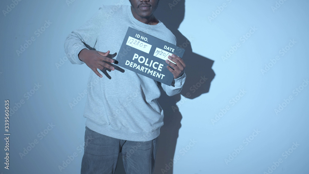 Gangster poses for a photo at the police station Stock Photo | Adobe Stock