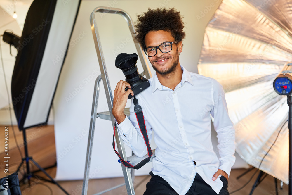 Successful photographer in the photo studio with camera Stock Photo ...