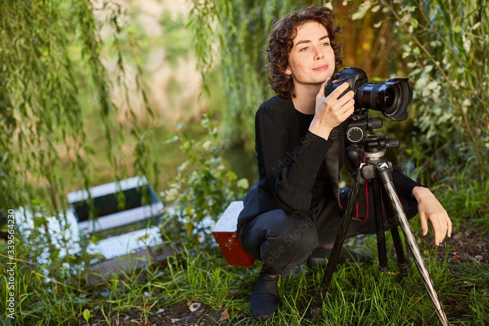 Landscape photographer with camera and tripod Stock Photo | Adobe Stock