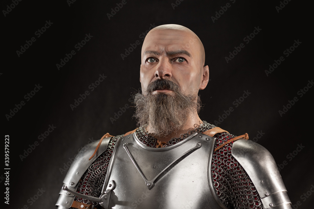 Mannequin man with a beard in a helmet and armor of a knight posing on ...