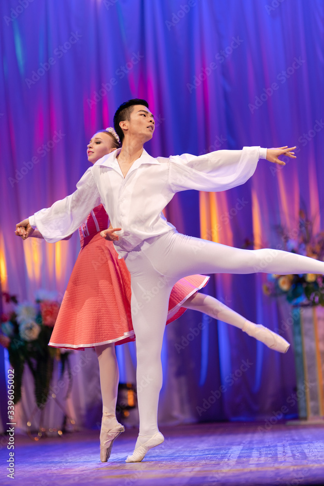 Trio of young girls ballerinas and a young man dancing ballet ...