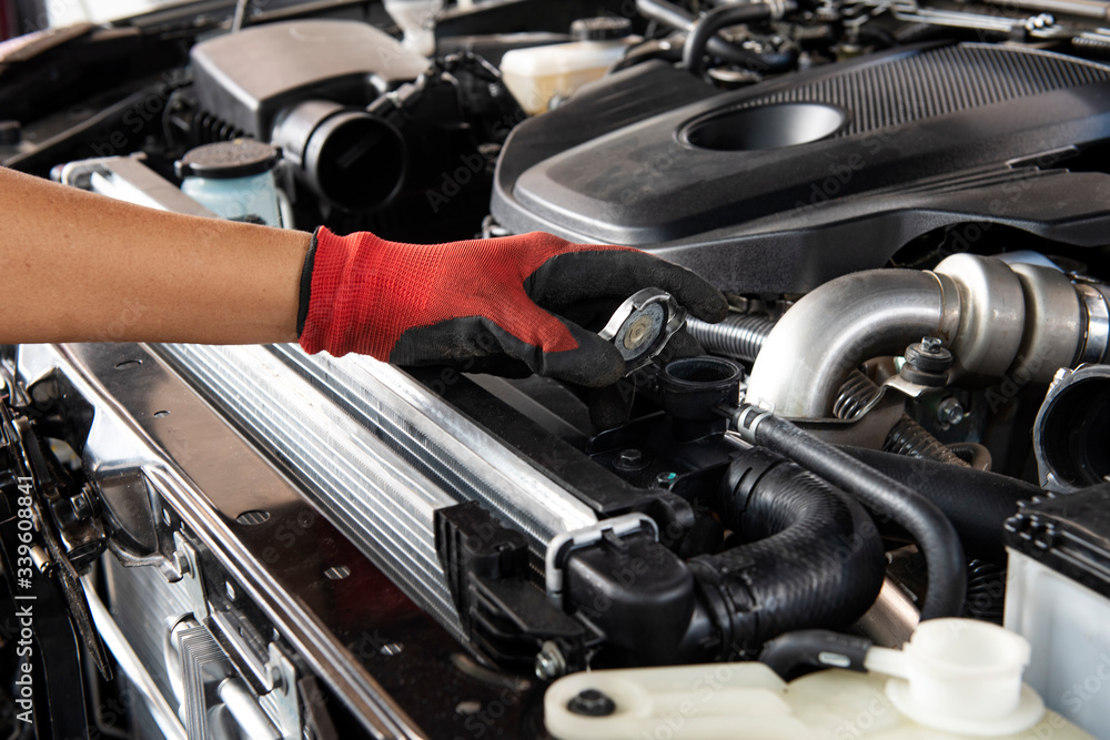 Mechanic check the radiator car. Hands of mechanic working in auto ...
