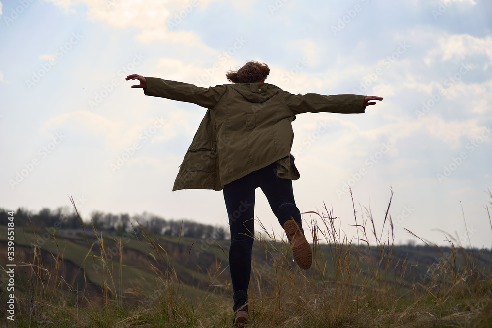 Alone girl on beautiful mountain view feeling free with wind and sky ...