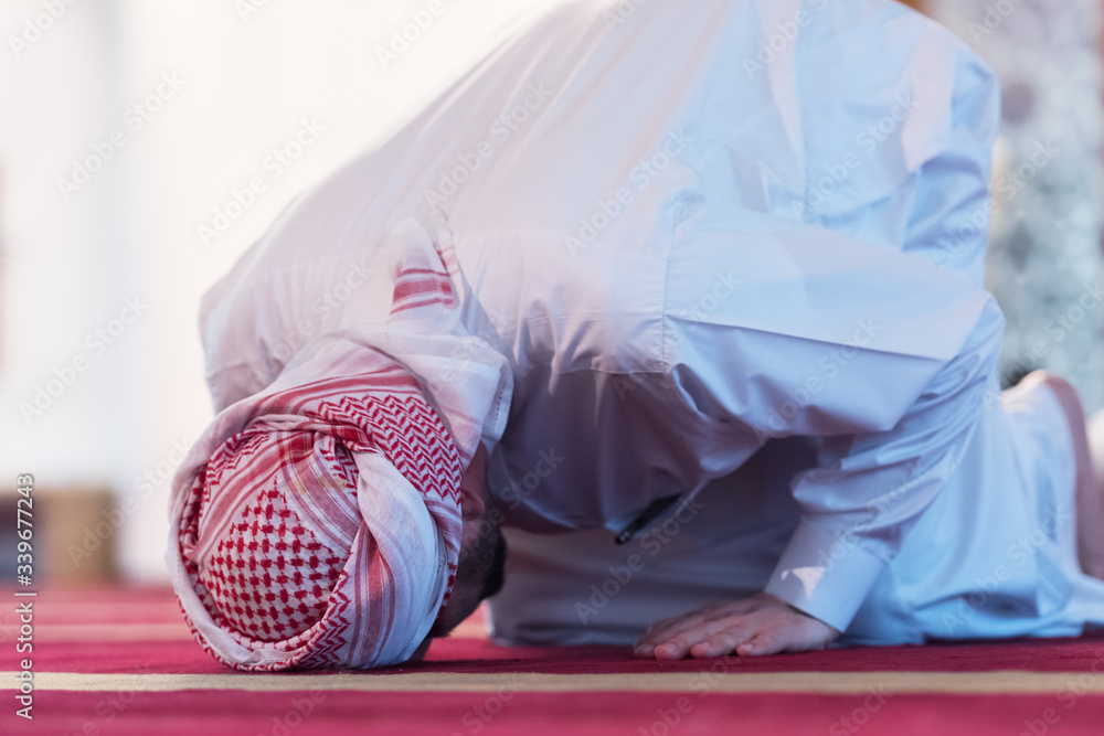 Young Arabic Muslim man praying. Doing a dailly pray inside modern ...