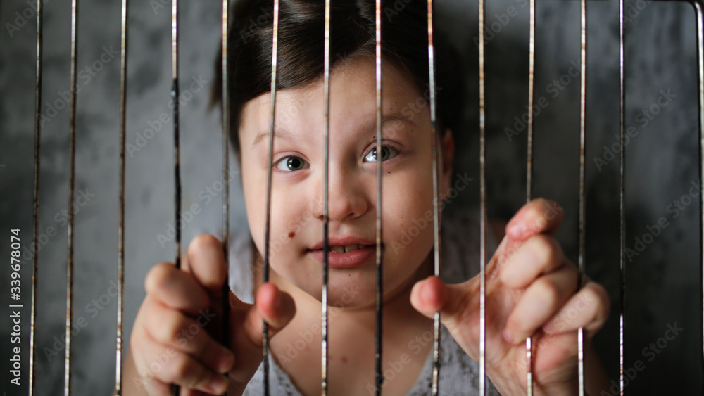 Kid in cage, concept freedom and rights of child Stock Photo | Adobe Stock