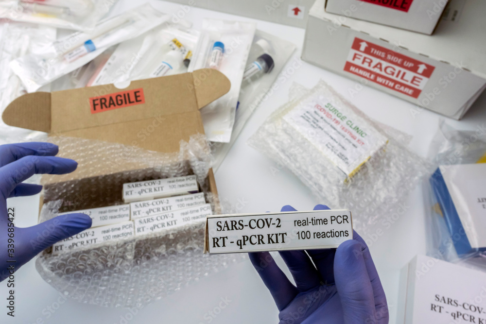 Nurse unpacking box with Covid-19 PCR kit in hospital warehouse ...
