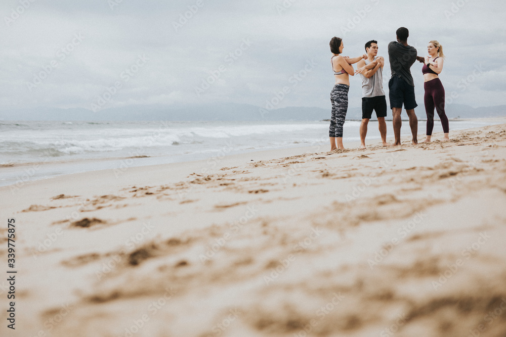 Pre-workout stretch at the beach Stock Photo | Adobe Stock