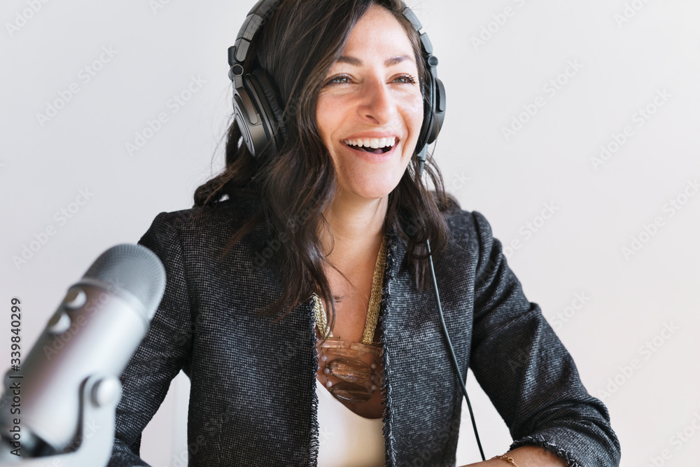 Woman recording her own podcast Stock Photo | Adobe Stock