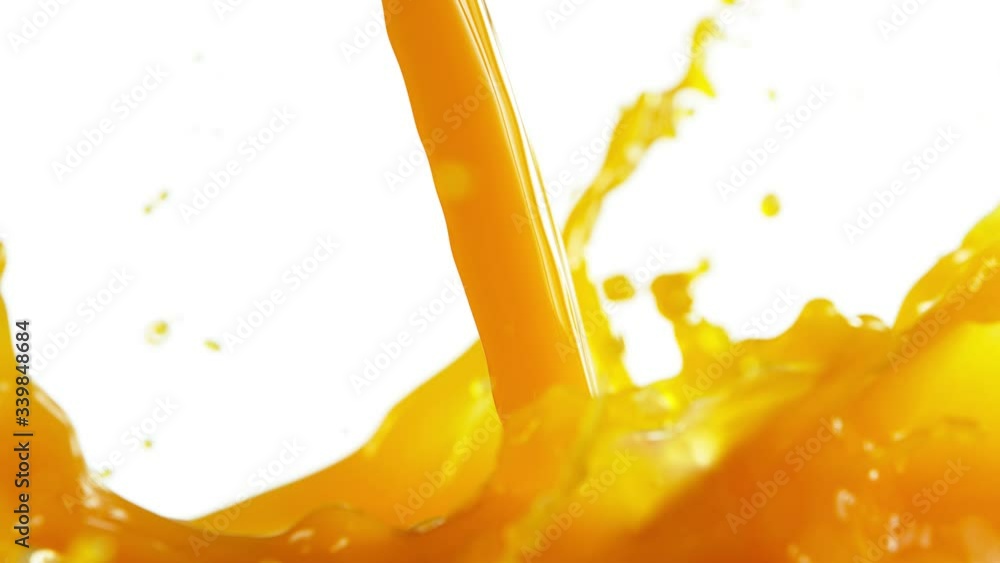 Super slow motion of pouring orange juice isolated on white background ...