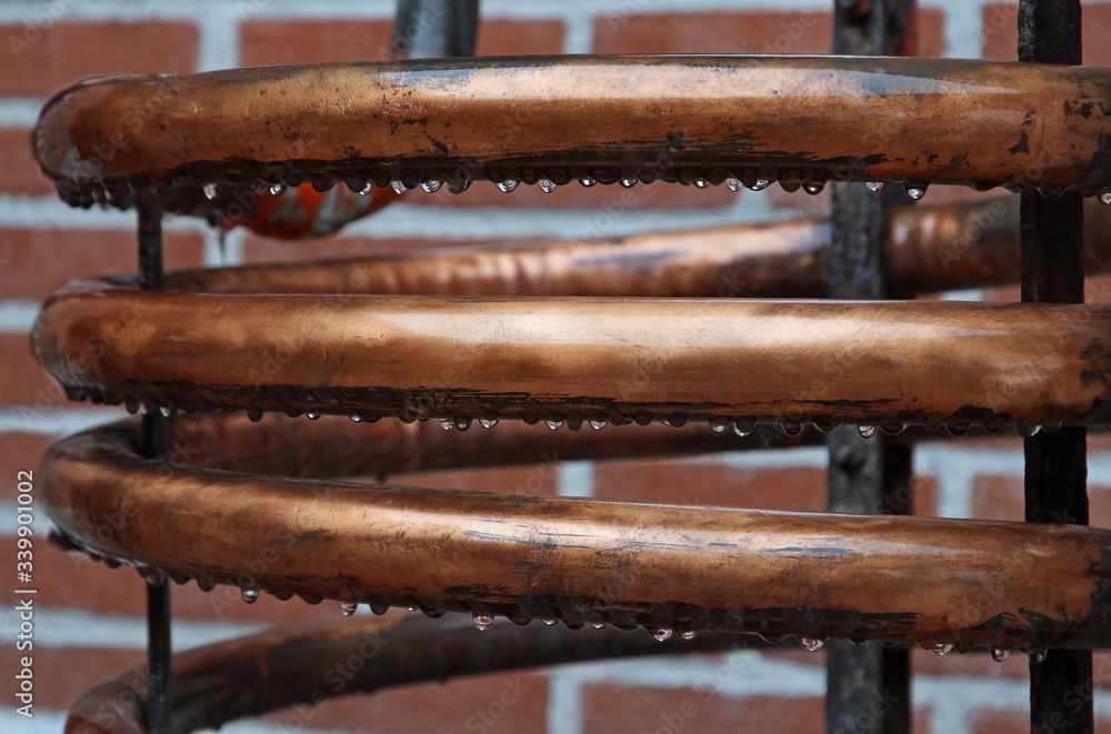 wet copper coil for the distillation of spirits in a distillery Stock ...