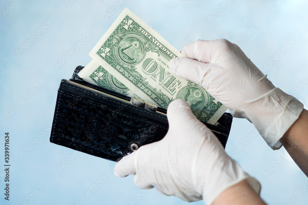 woman taking money out female wallet wearing rubber gloves to prevent ...