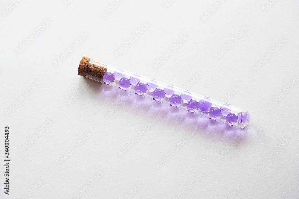 Bright purple hydrogel of a round shape in a transparent flask with a ...