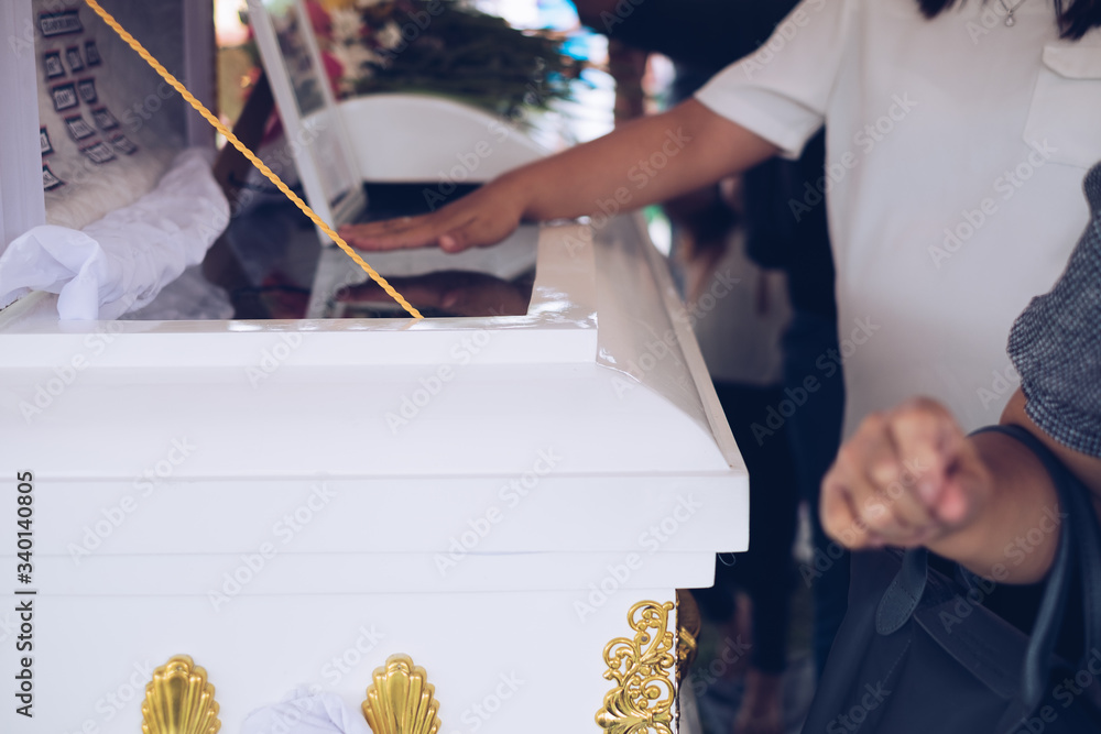 People saying their final goodbye to the deceased. Selective focus ...