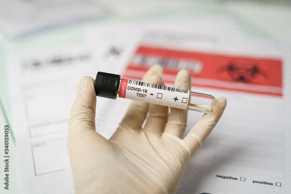 Hand holding COVID-19 swab collection kit, specimen sample testing ...