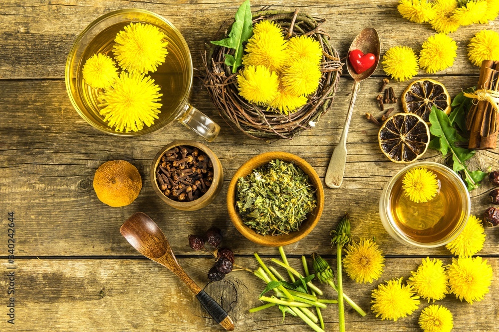 Herbal tea infusion of fresh dandelion leaf, with yellow blossoms ...