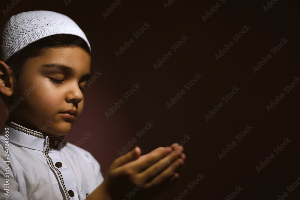 Praying muslim boy Stock Photo | Adobe Stock