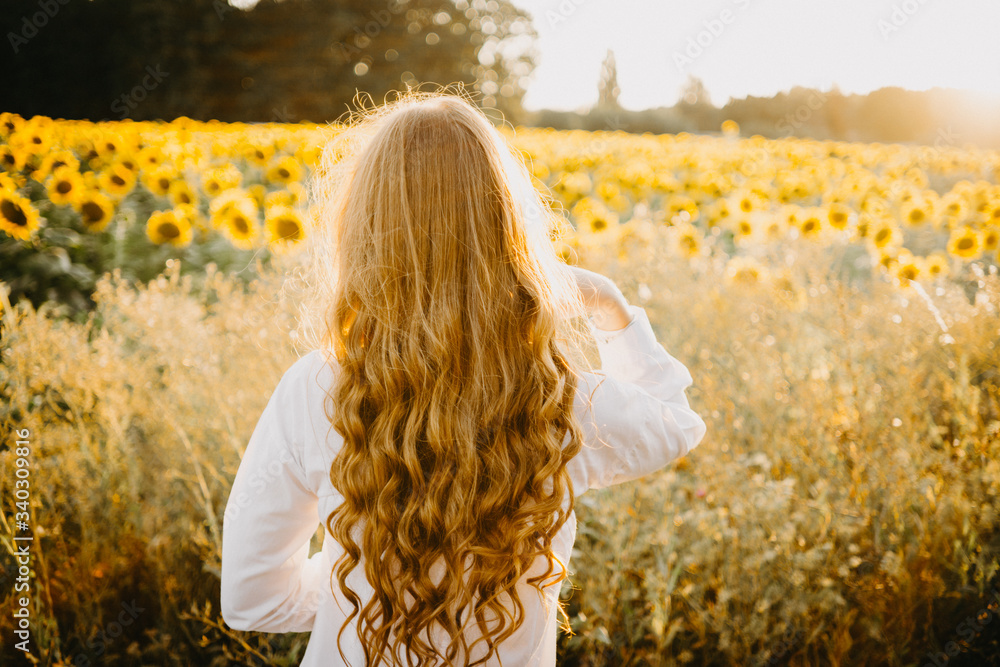 Beautiful young girl with red wavy hair and freckles in white dress ...