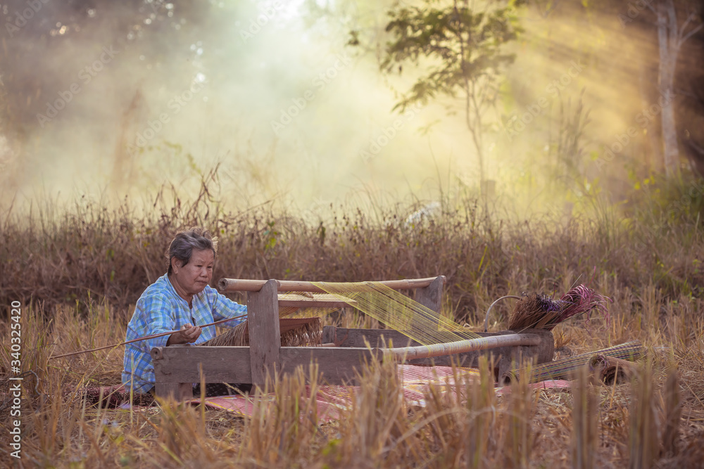 Craftsperson working. Old woman weaving the mat. Senior women making ...