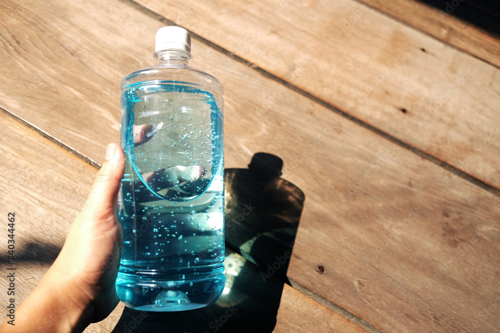Hand holding a bottle of Ethanol or ethyl alcohol gel for based hand ...