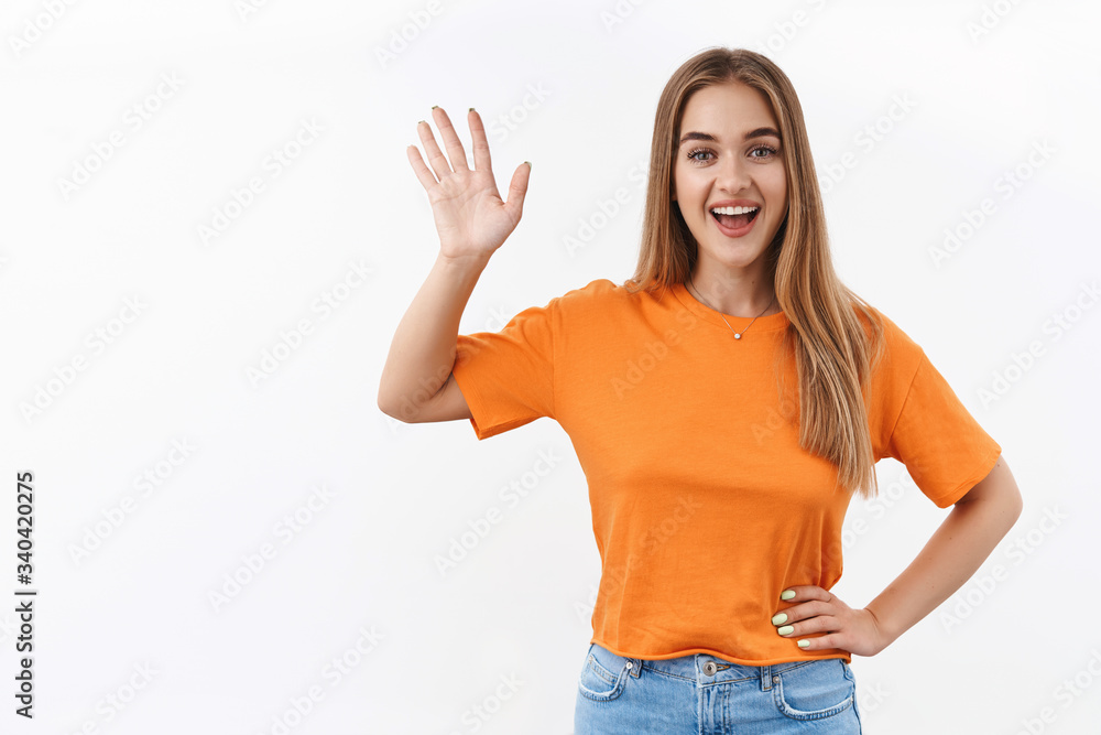 Hello neighbour. Smiling blond girl standing near window at home during ...