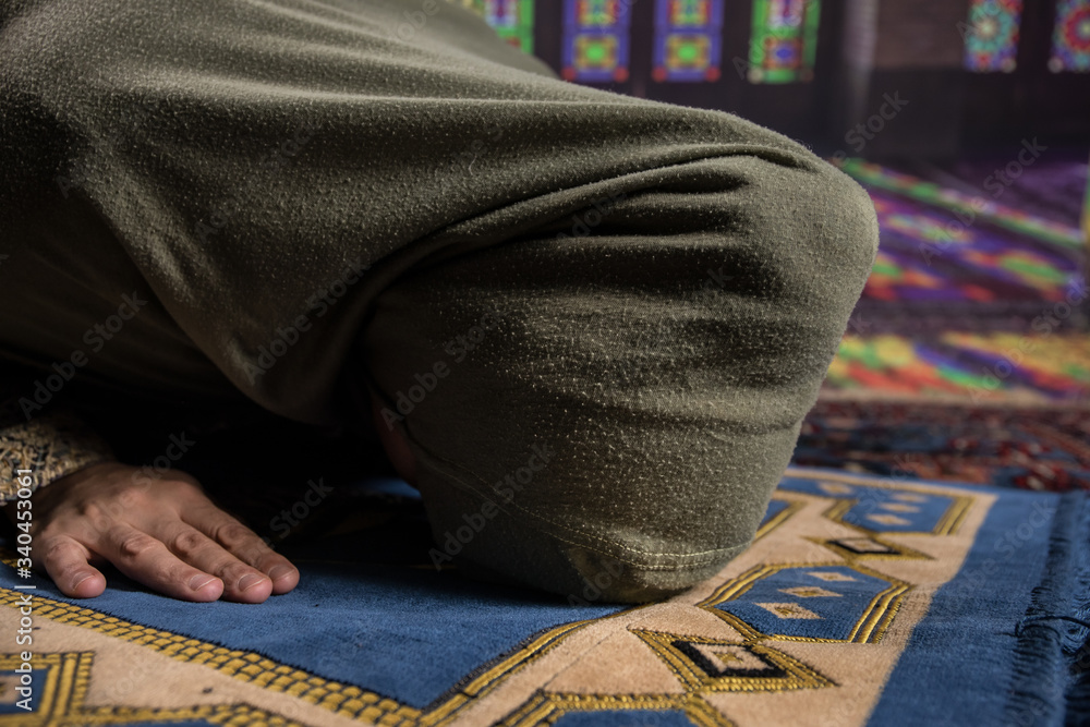 Muslim woman praying for Allah muslim god at room near window. Hands of ...