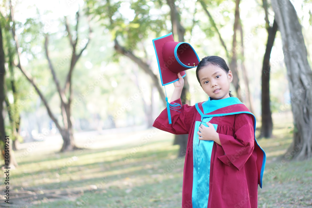 Foto de Asian child or kid girl happy smiling and little graduate wear ...