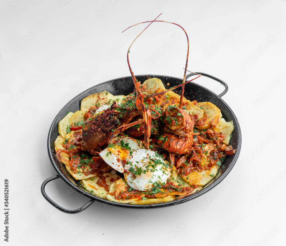 Formentera Lobster with fried potatoes, eggs and parsley in a ...