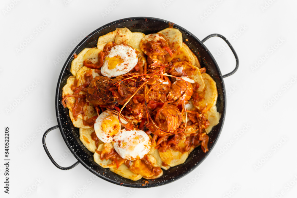 Formentera Lobster with fried potatoes, eggs and parsley in a ...