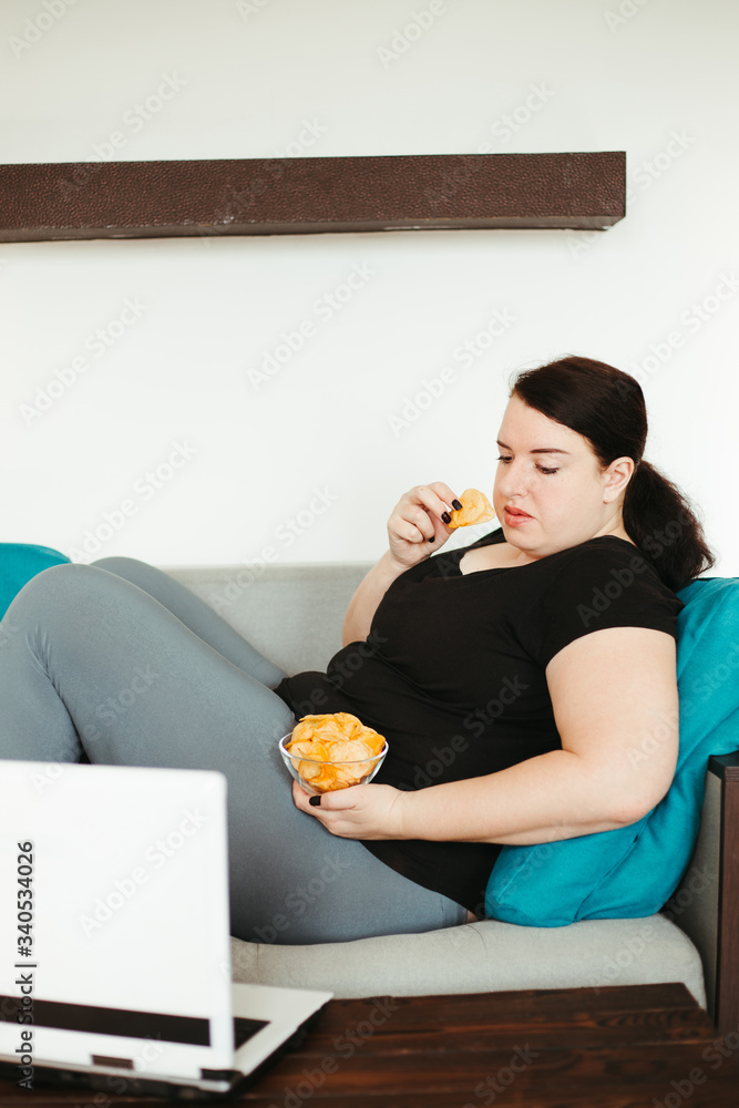 Overeating and gluttony concept. Mindless snacking, home sedentary ...
