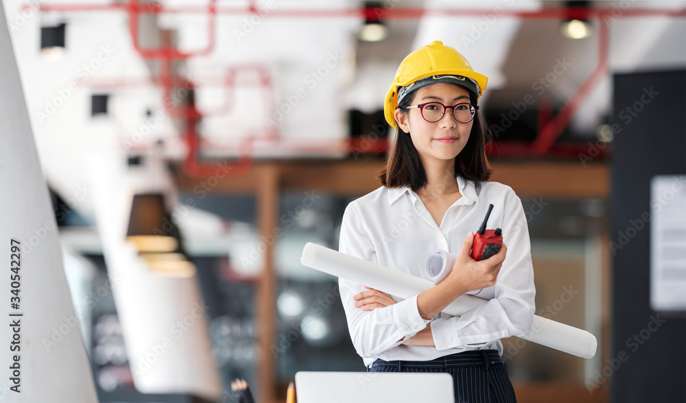 Beautiful female engineer standing in office. Stock Photo | Adobe Stock
