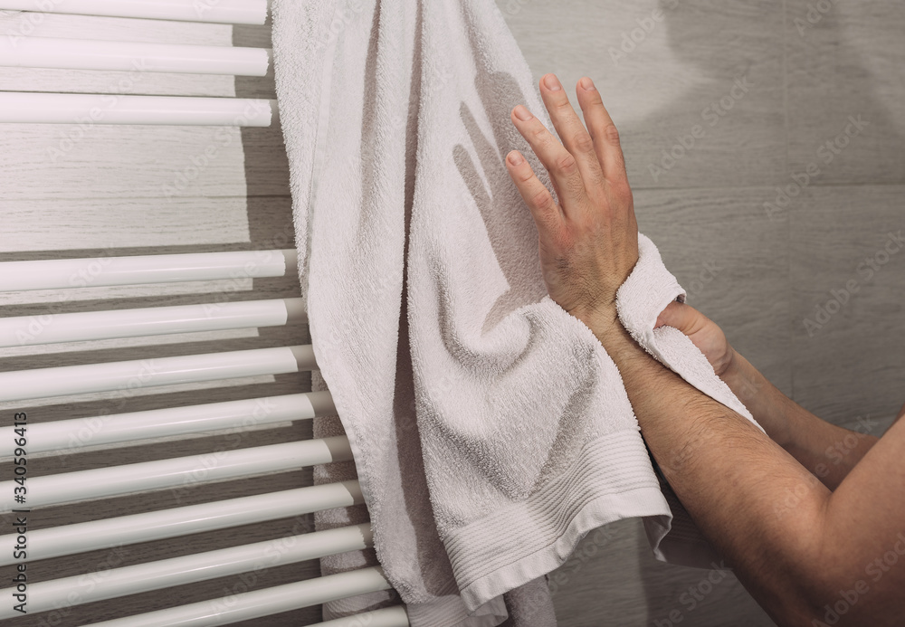 Fotka „Person using towel for wiping hands dry after washing in ...