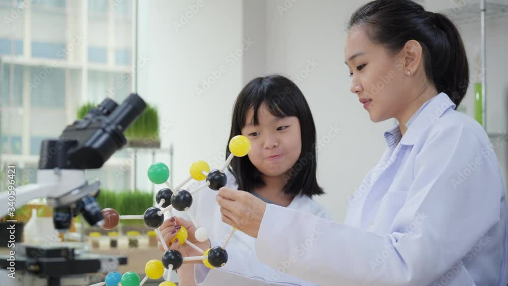 Asian teacher women or scientist female teaching children in classroom ...