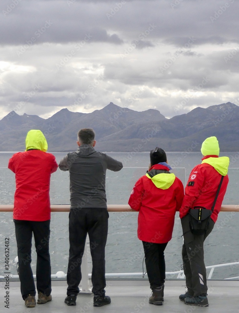 Explorers on expedition ship in chilean fjord watching the see, Strait ...