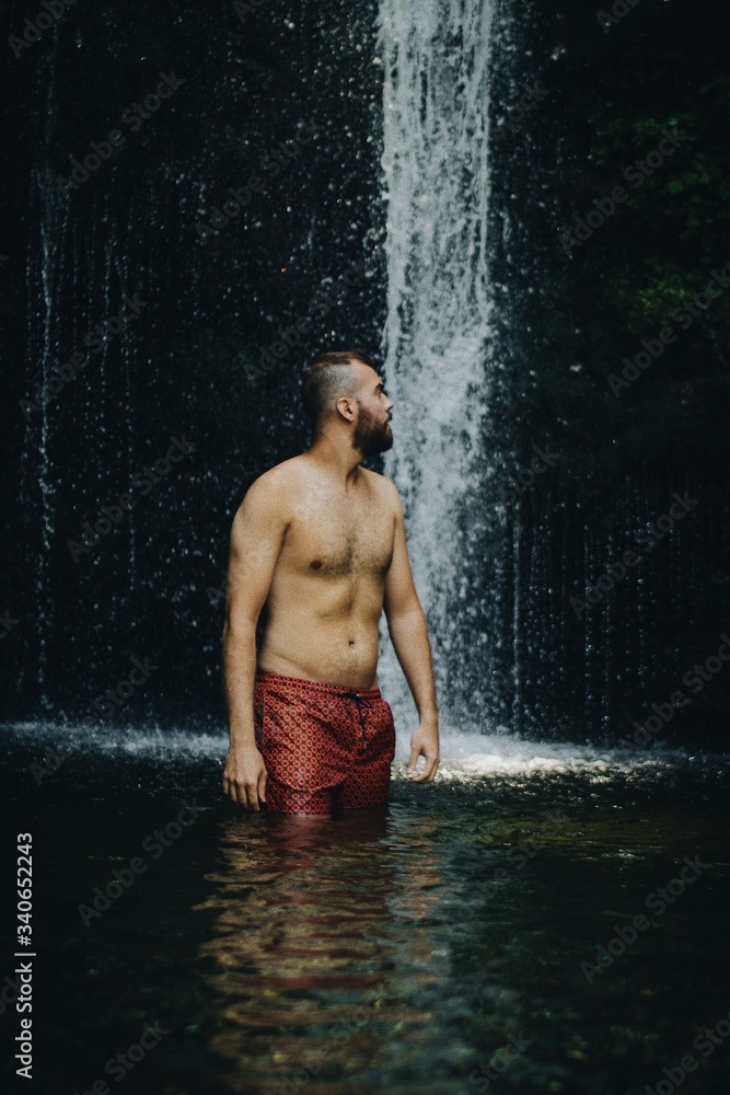 Young boy in a waterfall Stock Photo | Adobe Stock