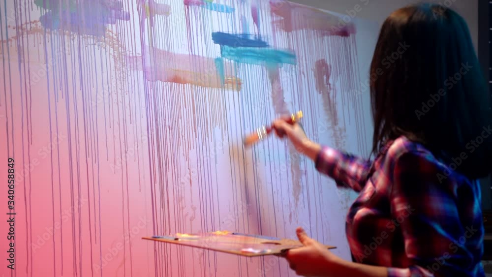 Young professional female artist drawing abstract contemporary art ...