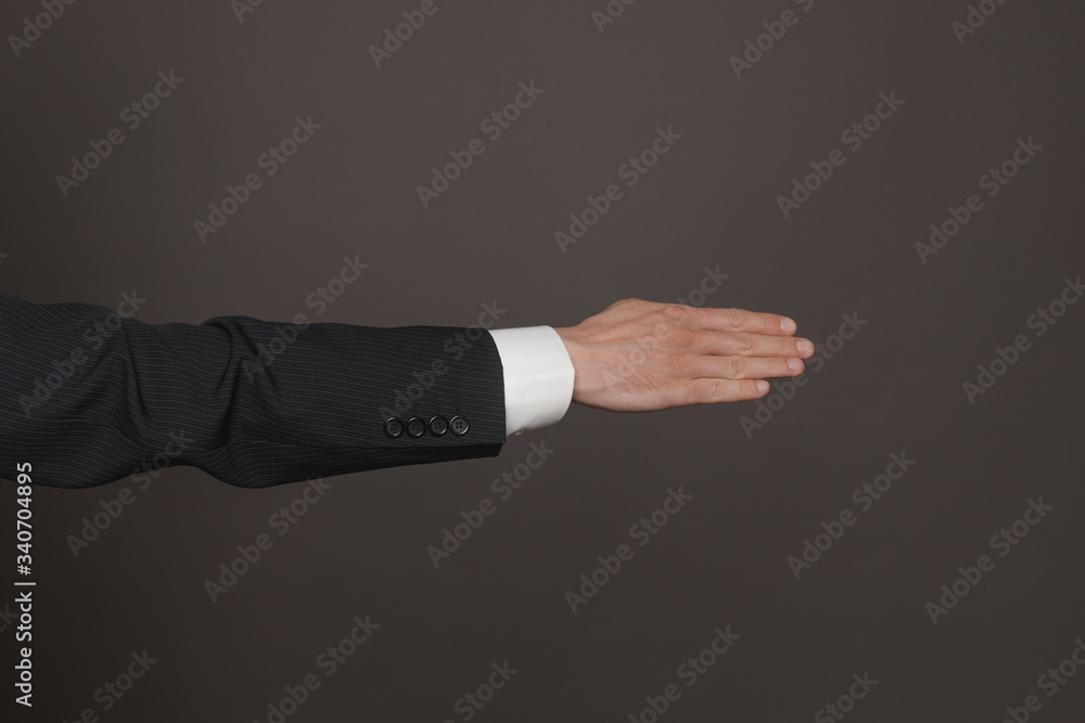 Man wearing formal suit showing direction with his arm pointing right ...